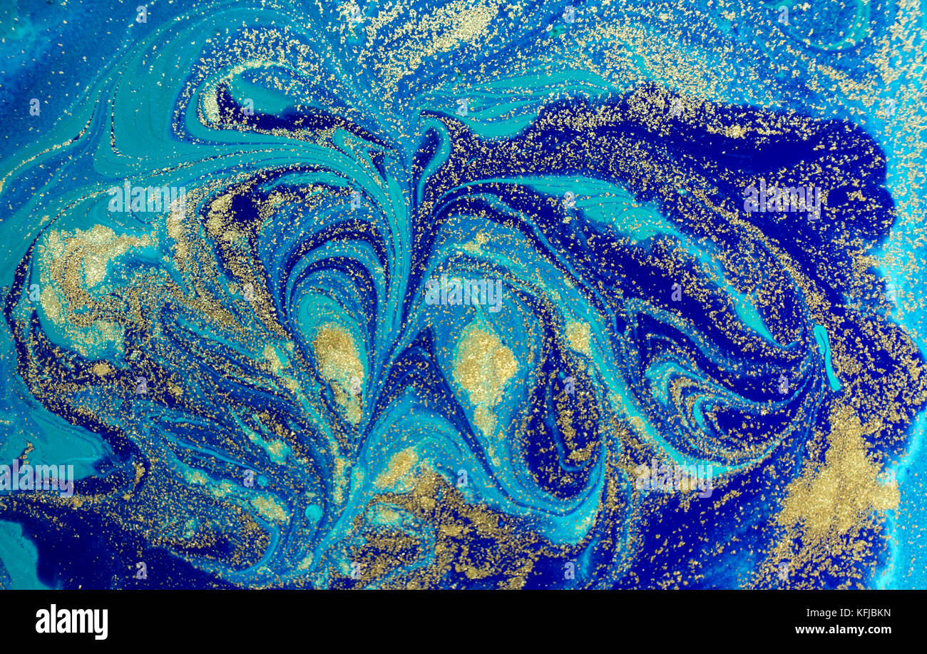 Marbled blue abstract background with golden sequins. Liquid marble ink ...