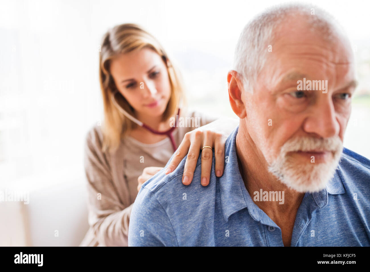 Health visitor and a senior man during home visit Stock Photo - Alamy