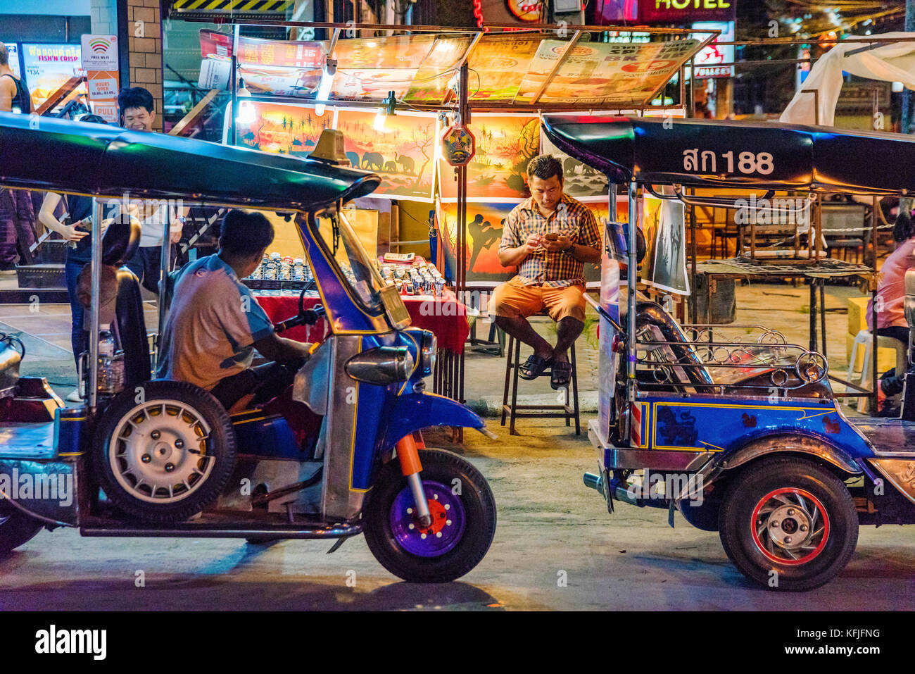 CHIANG MAI, THAILAND - JULY 30: Night market street scene of tuk tuks with stalls in the ...