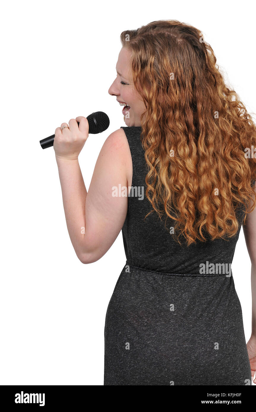 Beautiful woman singer performing at a concert Stock Photo - Alamy
