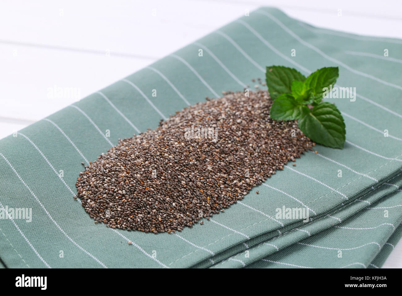 pile of chia seeds on grey place mat - close up Stock Photo - Alamy