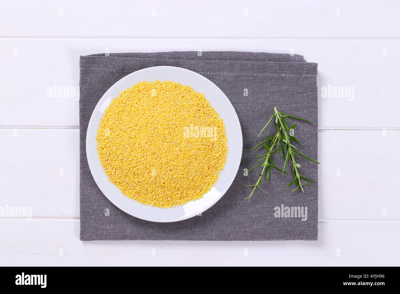 plate of raw millet on grey place mat Stock Photo - Alamy