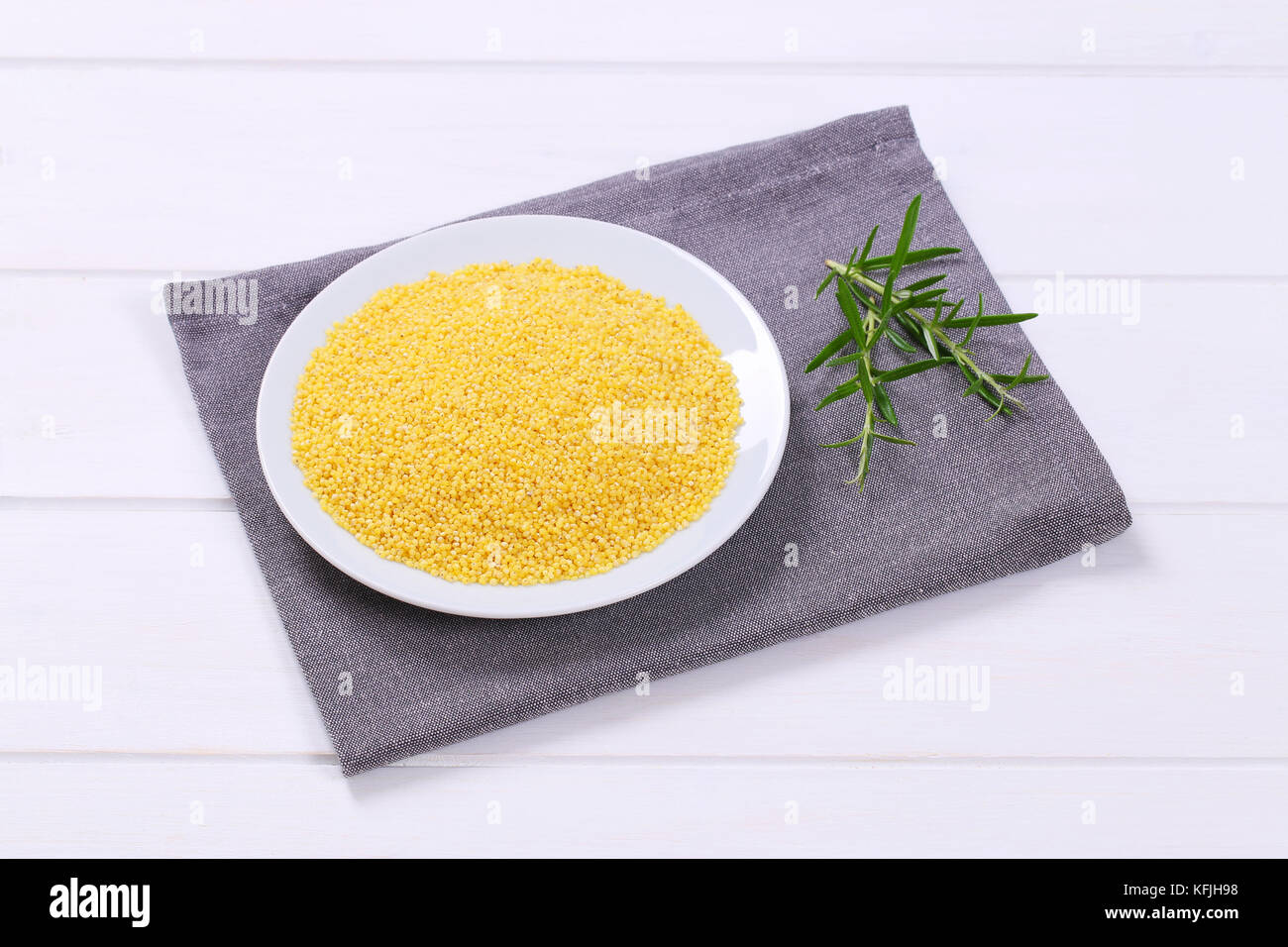 plate of raw millet on grey place mat Stock Photo - Alamy
