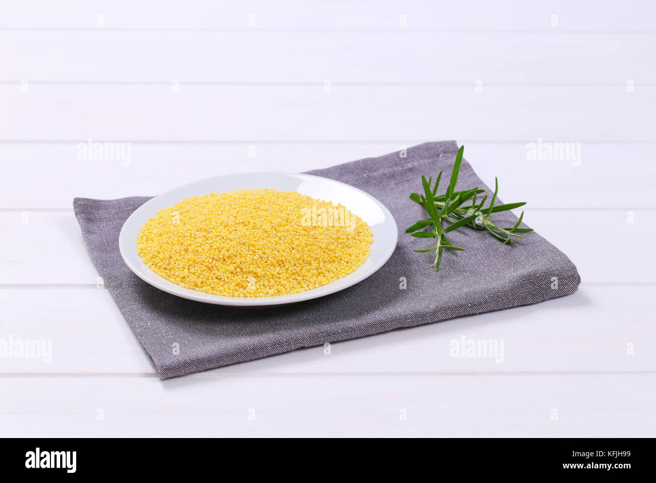 plate of raw millet on grey place mat Stock Photo - Alamy