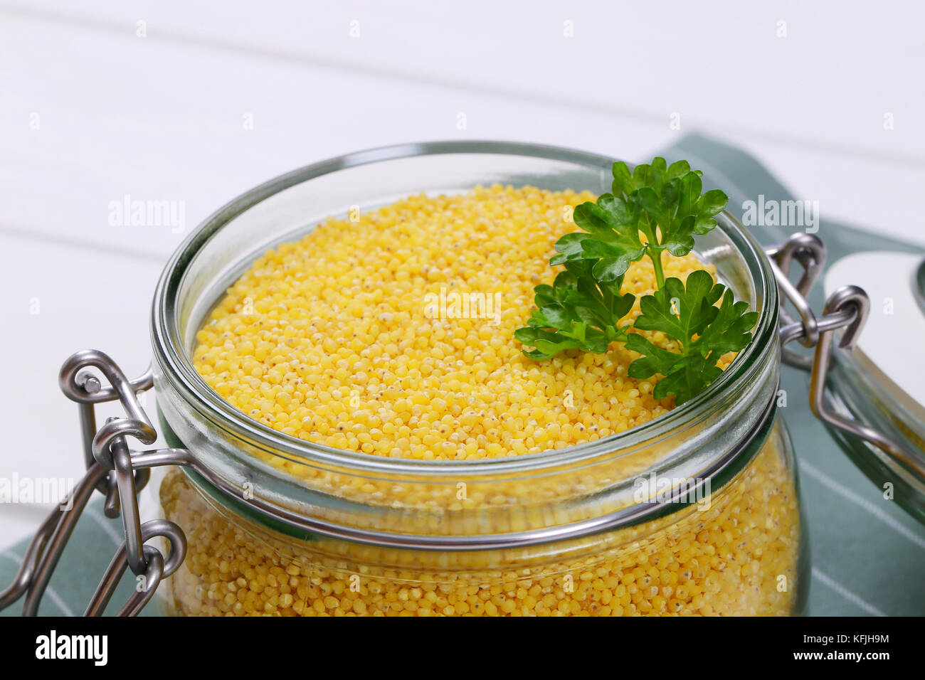 jar of raw millet on grey place mat - close up Stock Photo - Alamy