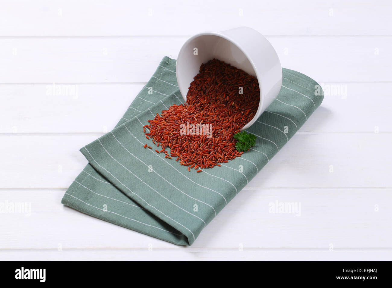 bowl of red rice spilt out on grey place mat Stock Photo - Alamy
