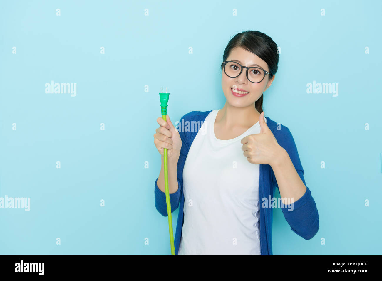 happy confident woman holding plug showing save electric concept and ...