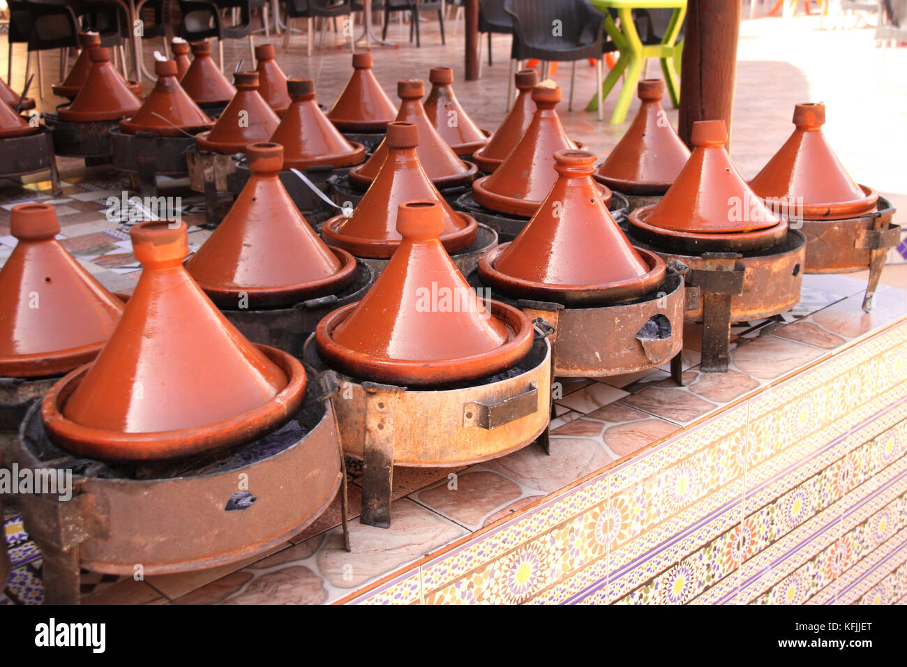 Cooking of meat in traditional Moroccan ceramic tajine dish, Marrakesh ...