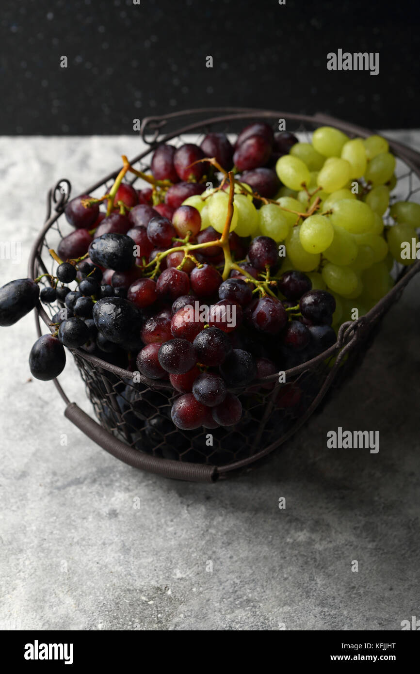 Grapes mix in basket Stock Photo - Alamy