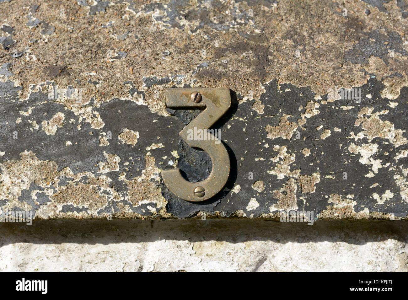 House number 3 sign on wall with peeling paint hi-res stock photography ...
