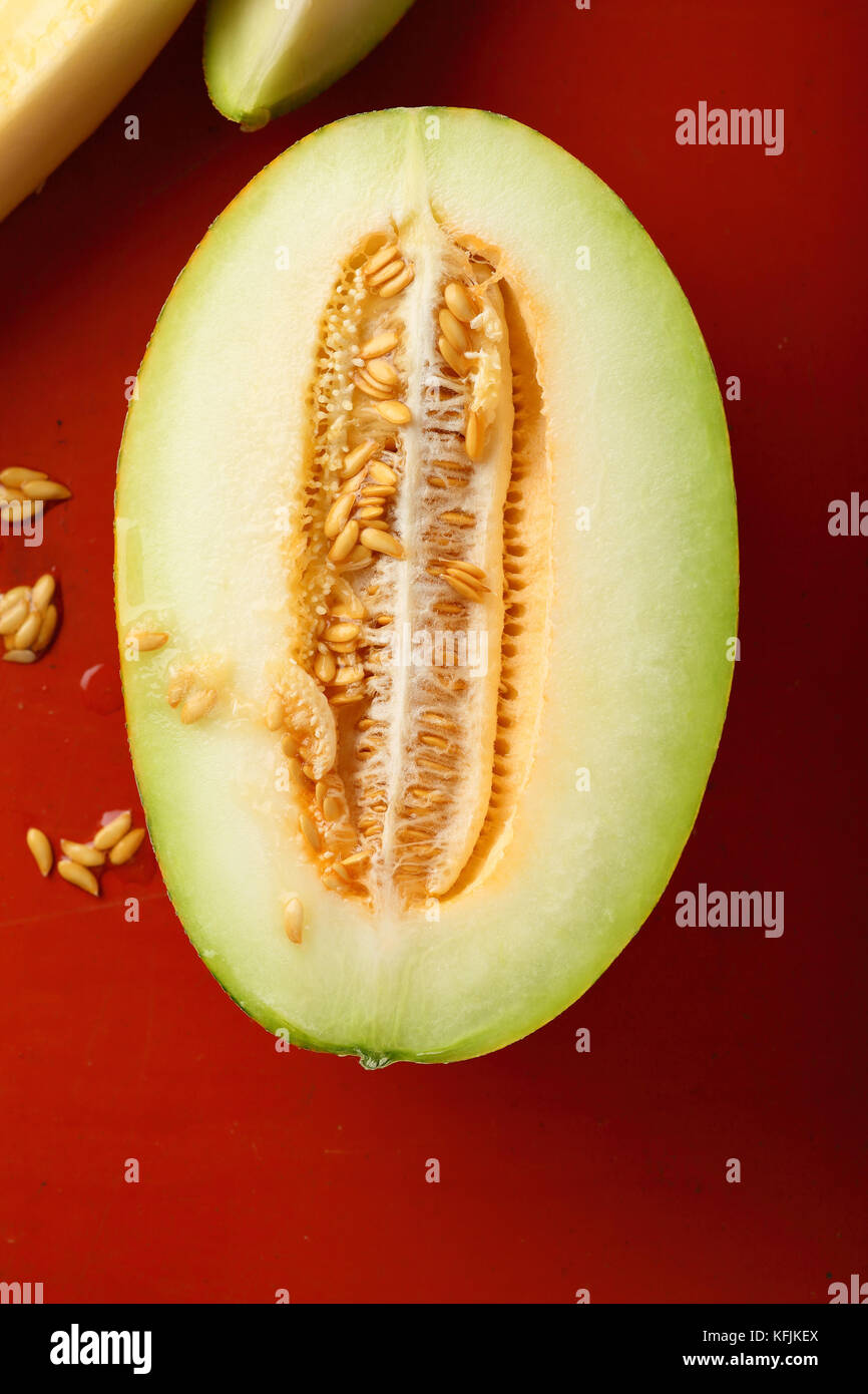 Half of melon slices on red background, food closeup Stock Photo - Alamy