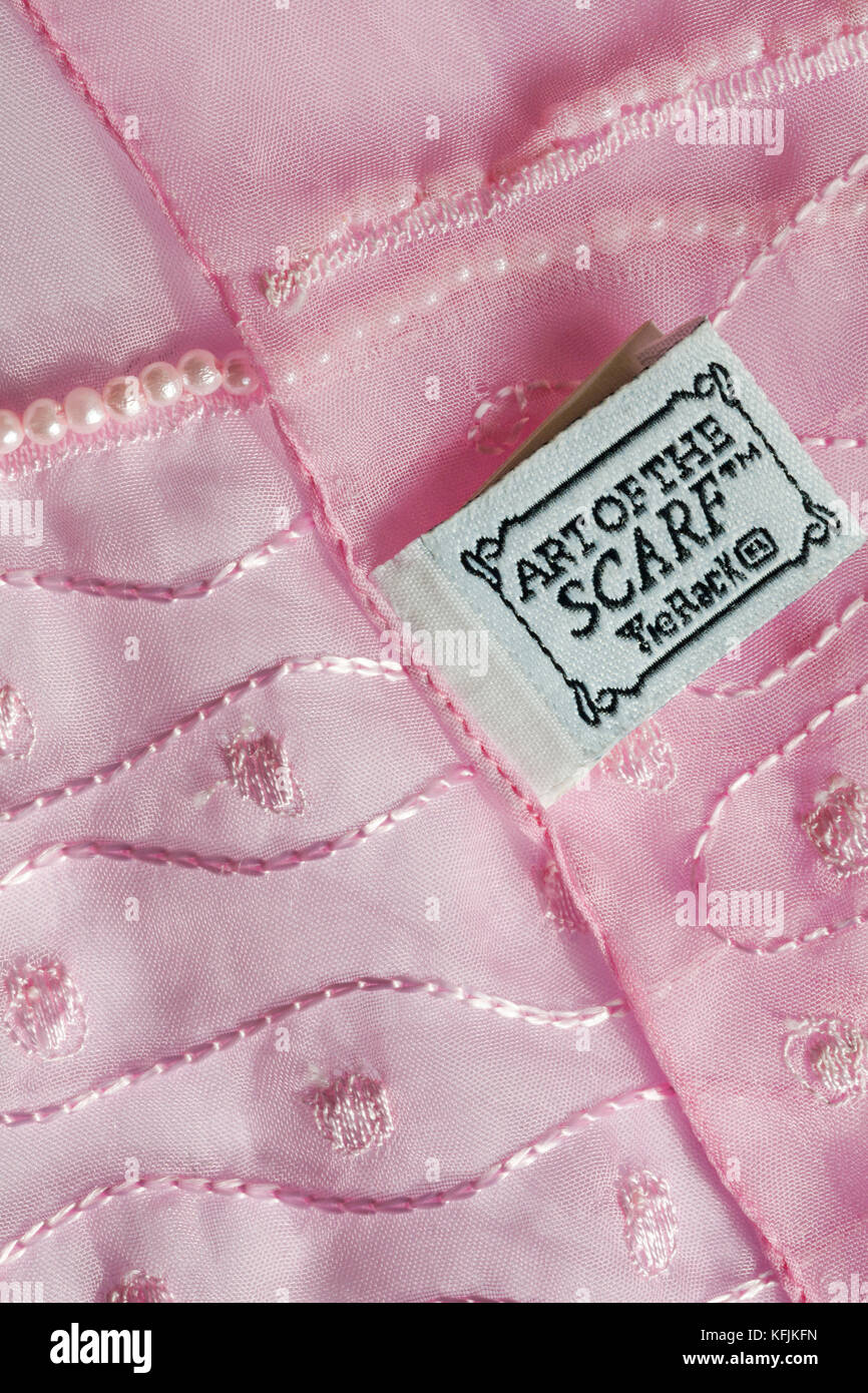 Art of the scarf Tie Rack Label in woman's pink decorative scarf Stock ...
