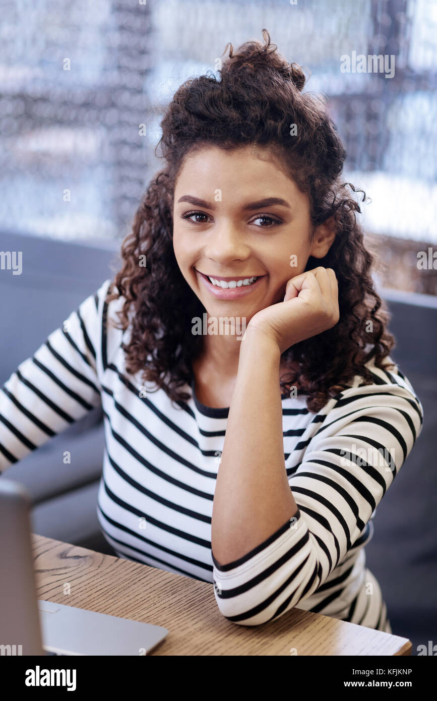 Pretty girl sitting at the table Stock Photo - Alamy