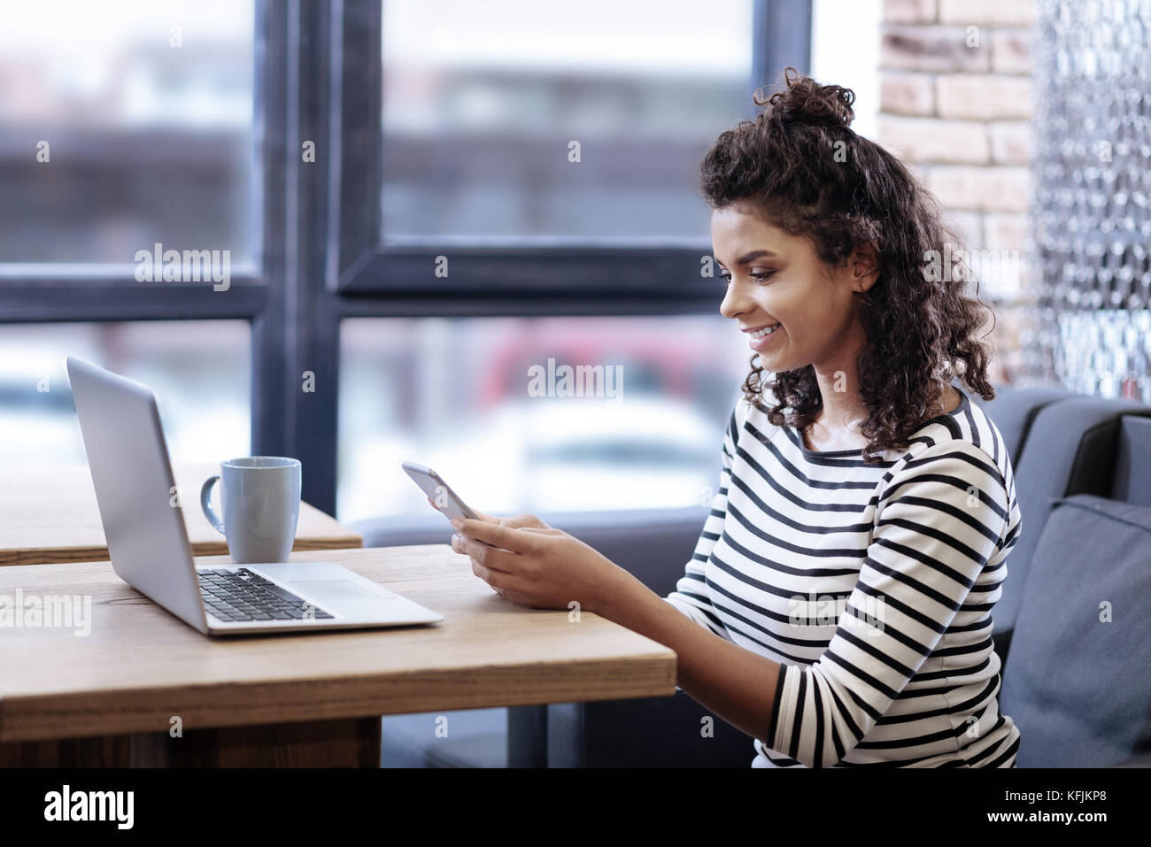Smiling girl looking at the phone Stock Photo - Alamy