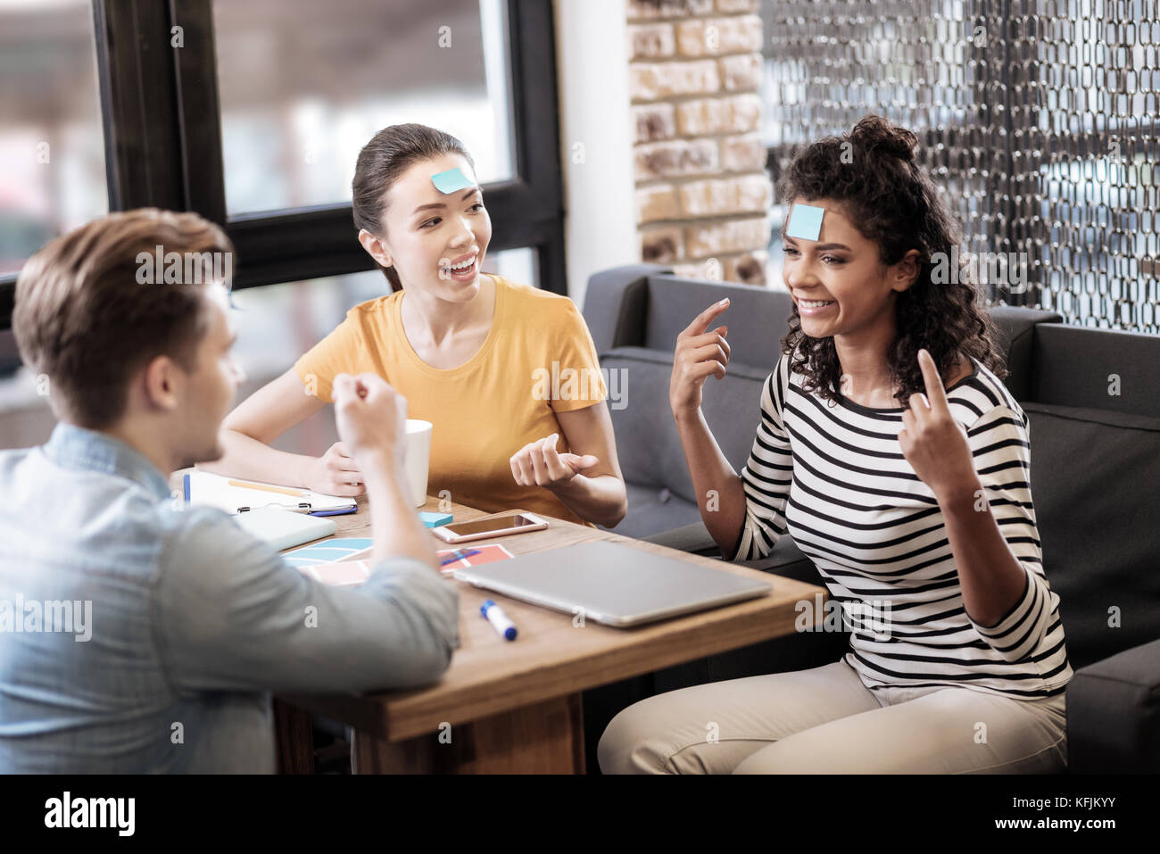 Funny girls sitting and playing a game Stock Photo - Alamy