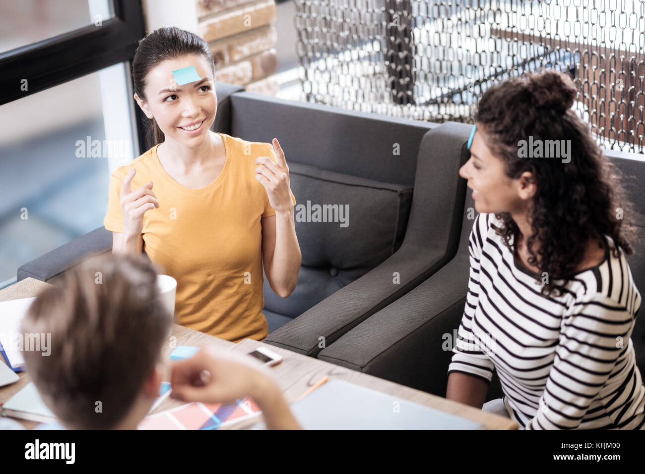 Cheerful girl playing a game with her friends Stock Photo - Alamy