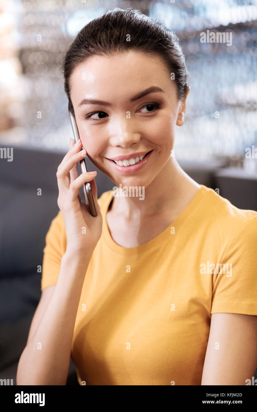 Joyful girl smiling and talking on the phone Stock Photo - Alamy