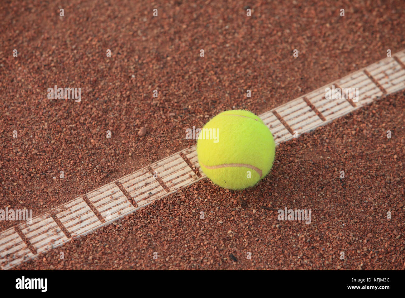 Tennis ball on the line, on clay court Stock Photo - Alamy