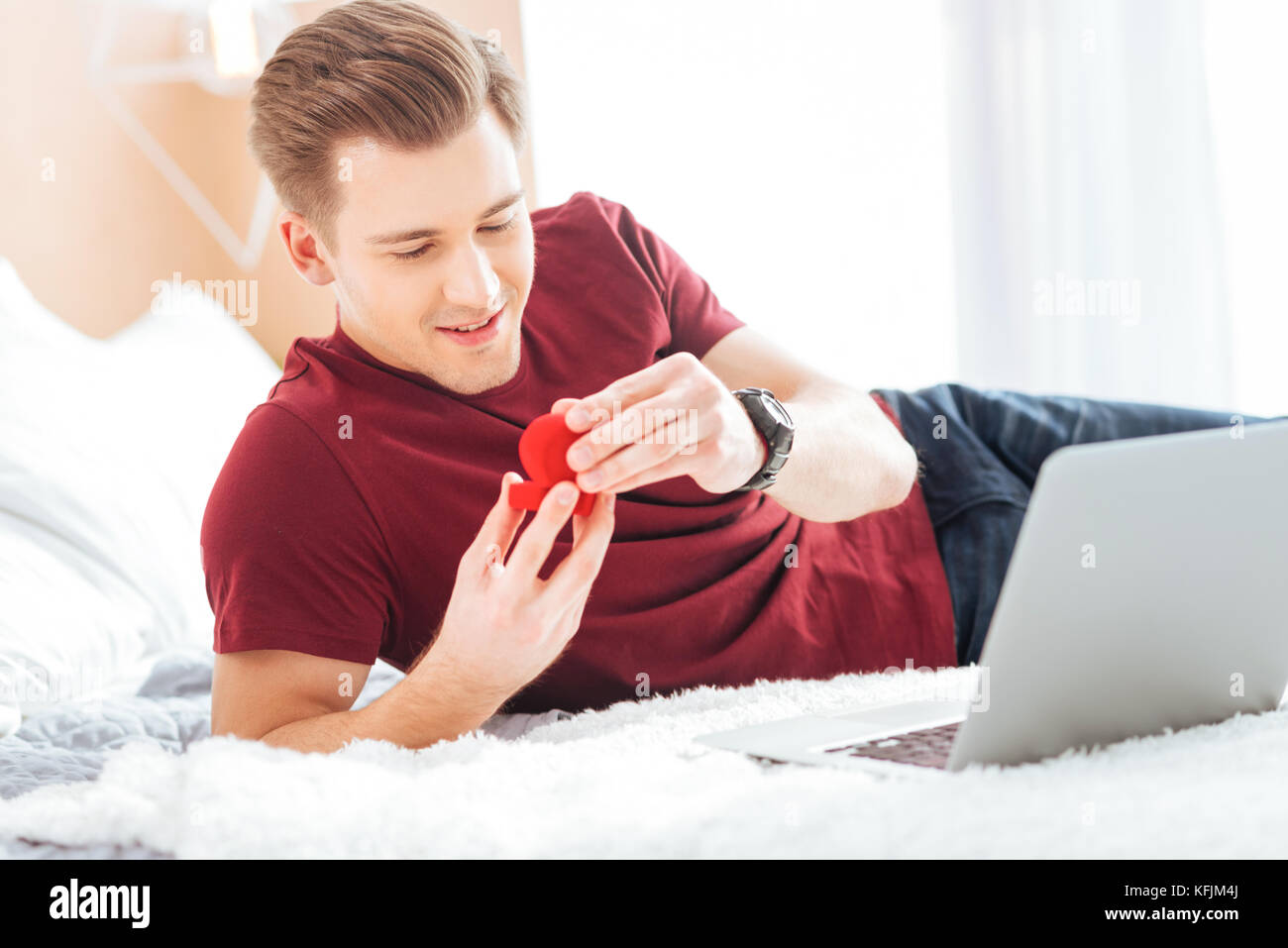 Loving young man looking at proposal ring Stock Photo - Alamy