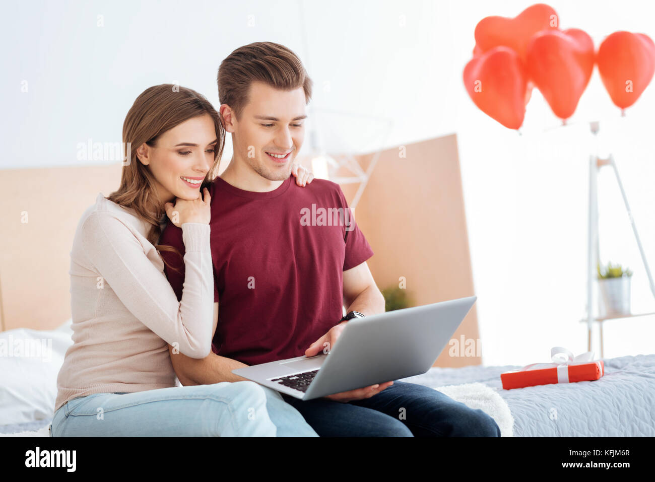 Charming couple using laptop together Stock Photo - Alamy