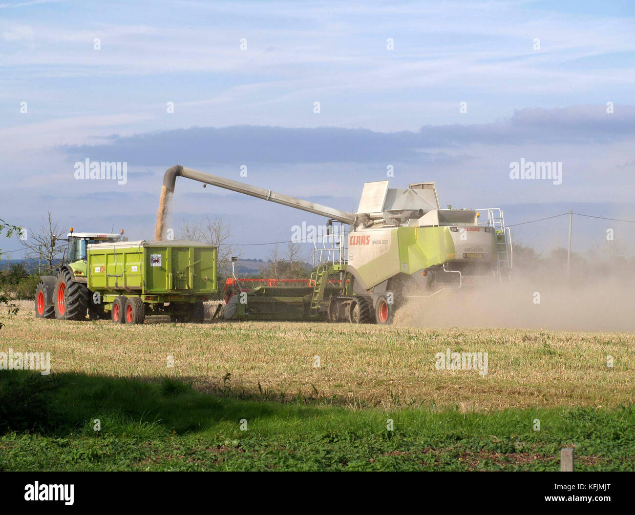Combine Harveste, tractor and trailer at work in field in Bosham ...