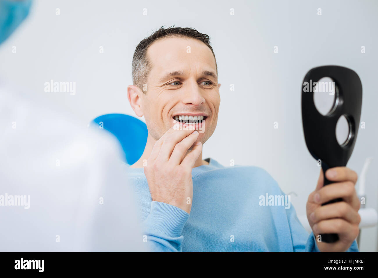 Happy joyful man looking at his reflection Stock Photo - Alamy