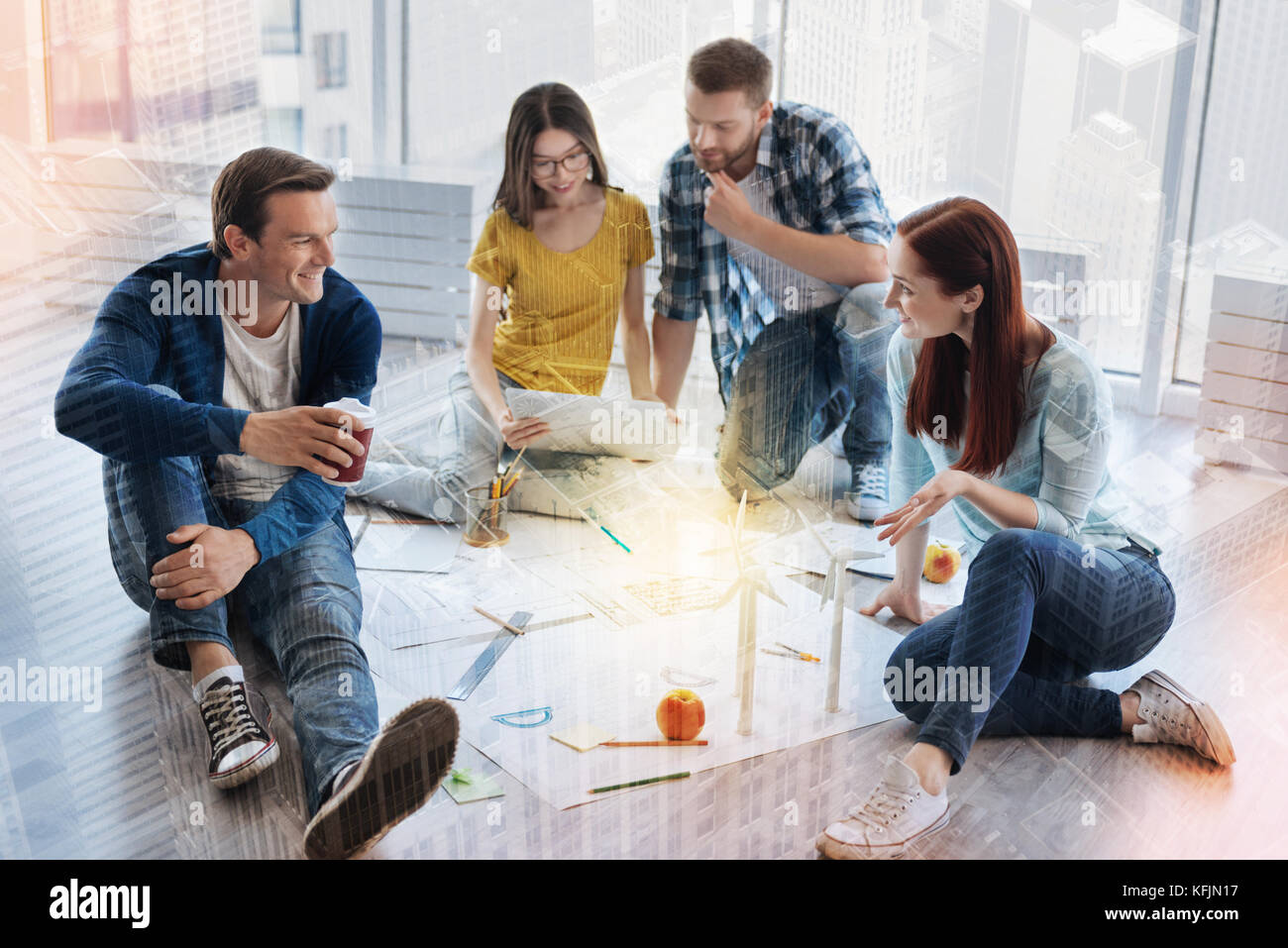 Young colleagues discussing their project Stock Photo - Alamy