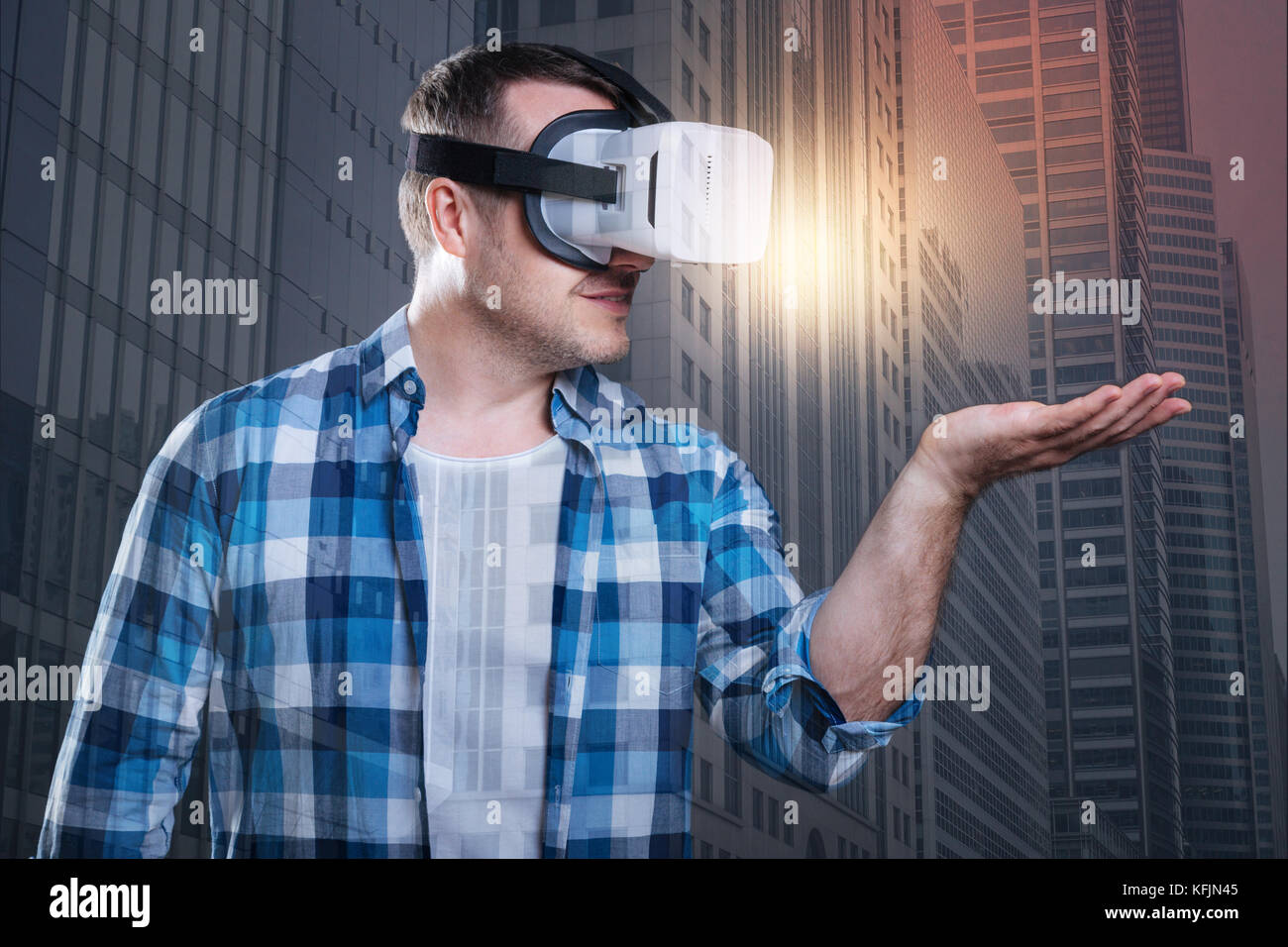 Cheerful man looking at the world in his modern device Stock Photo - Alamy