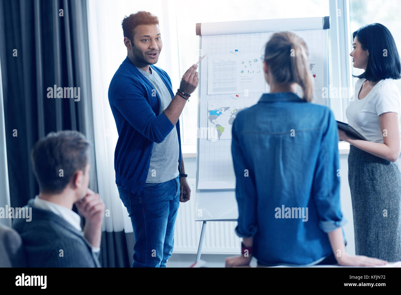 Positive delighted international designer talking to his friends Stock ...