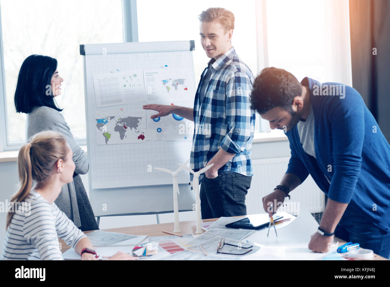 Handsome engineer standing near desk with pictures Stock Photo - Alamy