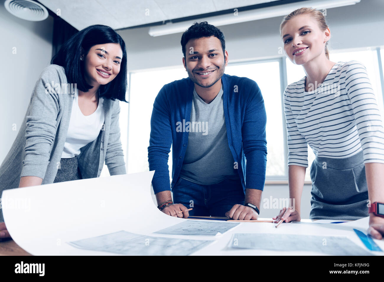 International engineer standing between his female colleagues Stock ...