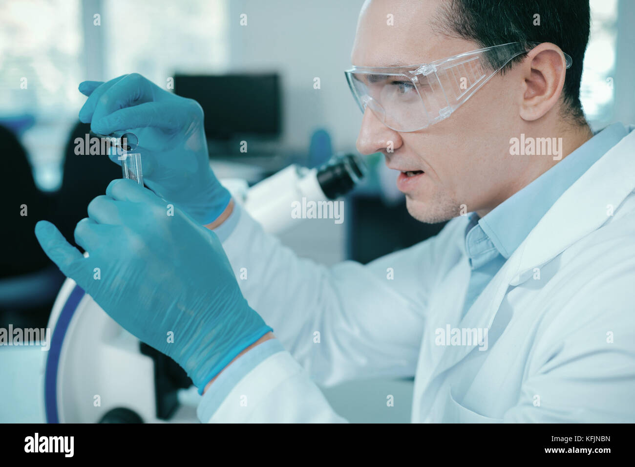 Profile picture of competent lab worker that mixing reagents Stock ...