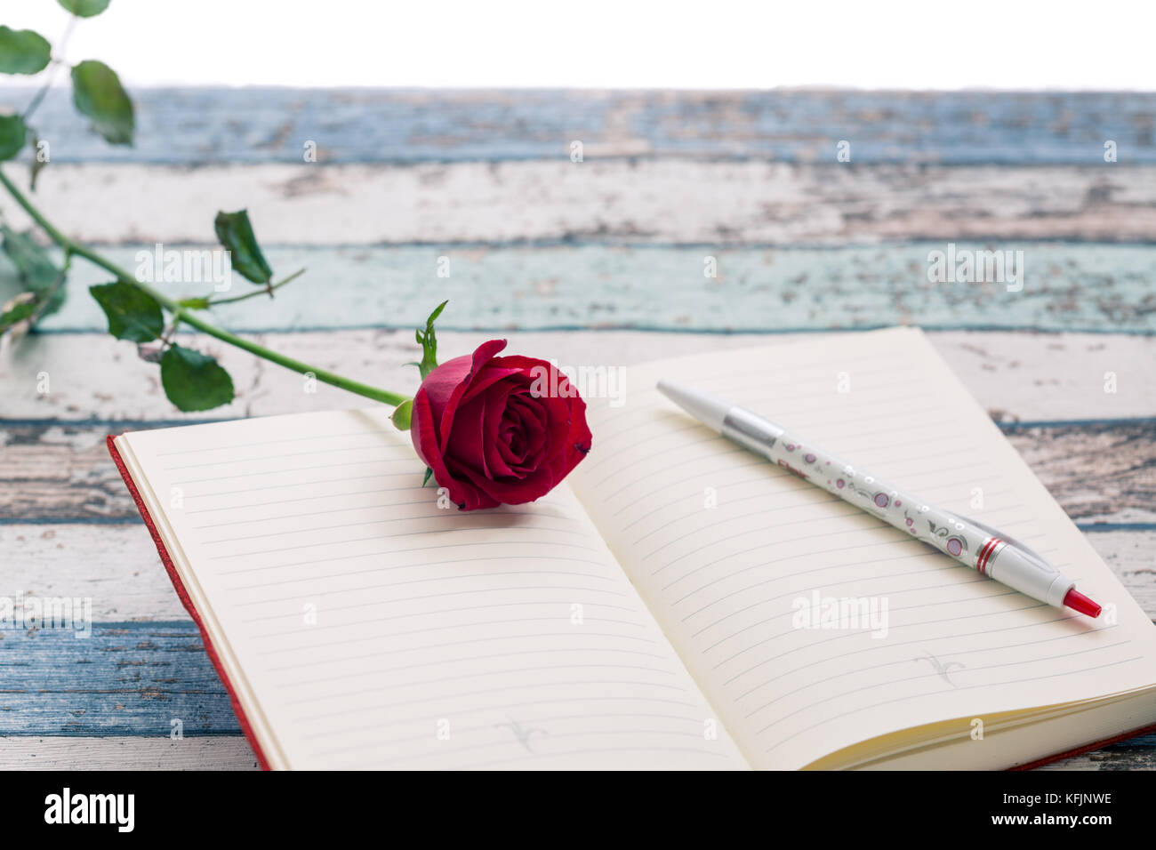 Writing for love: red rose, journal and pen Stock Photo - Alamy