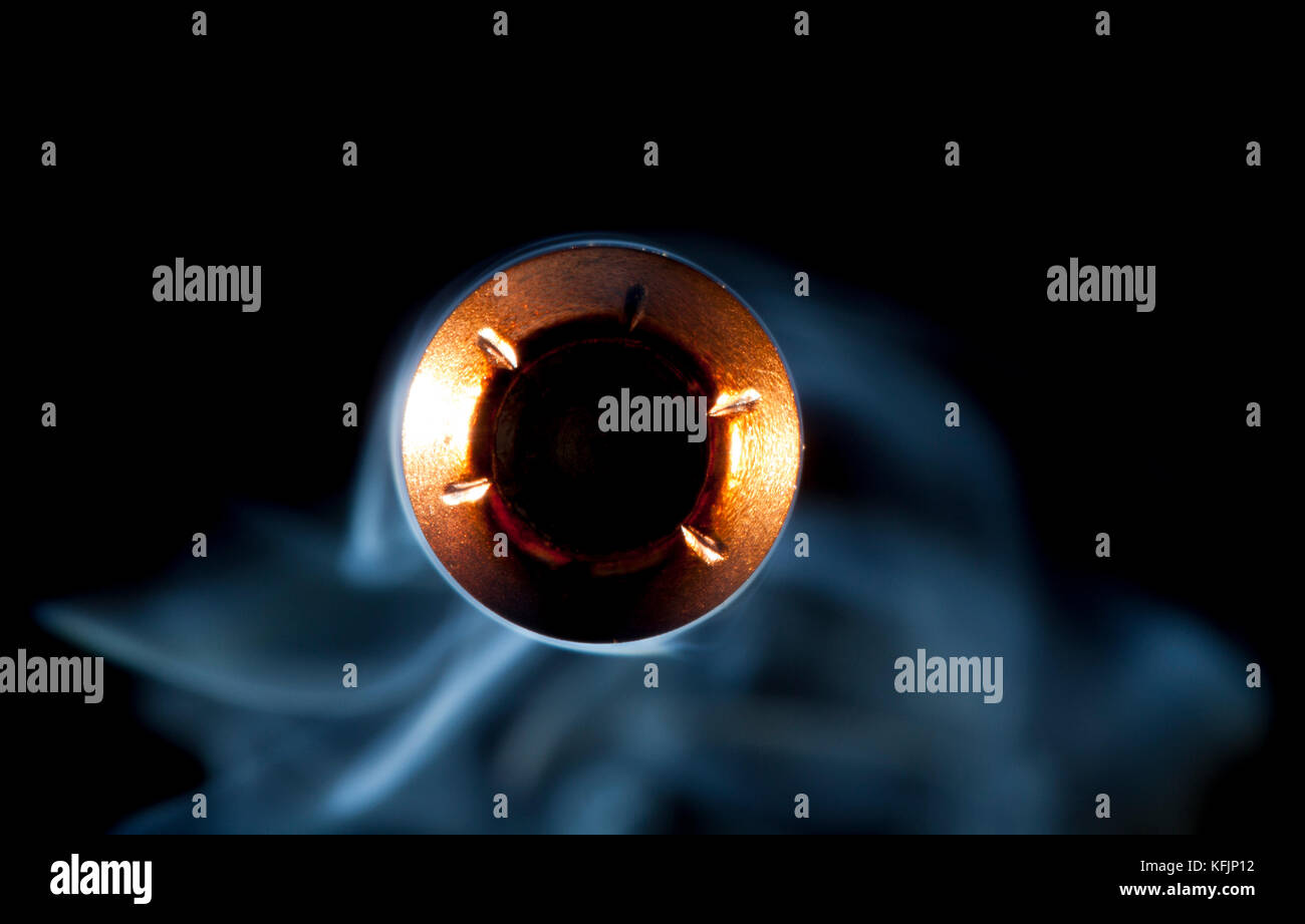 Bullet with a hollow point design pointing at the camera with smoke ...
