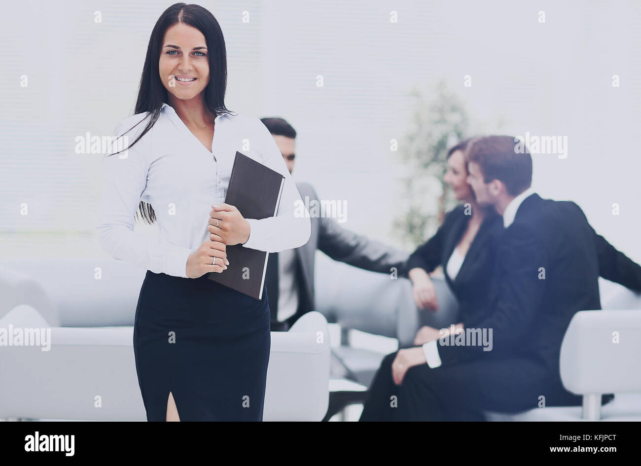 Successful business man standing with his staff in background at Stock ...