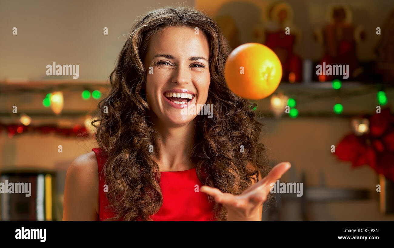 Happy young woman throwing orange hi-res stock photography and images ...