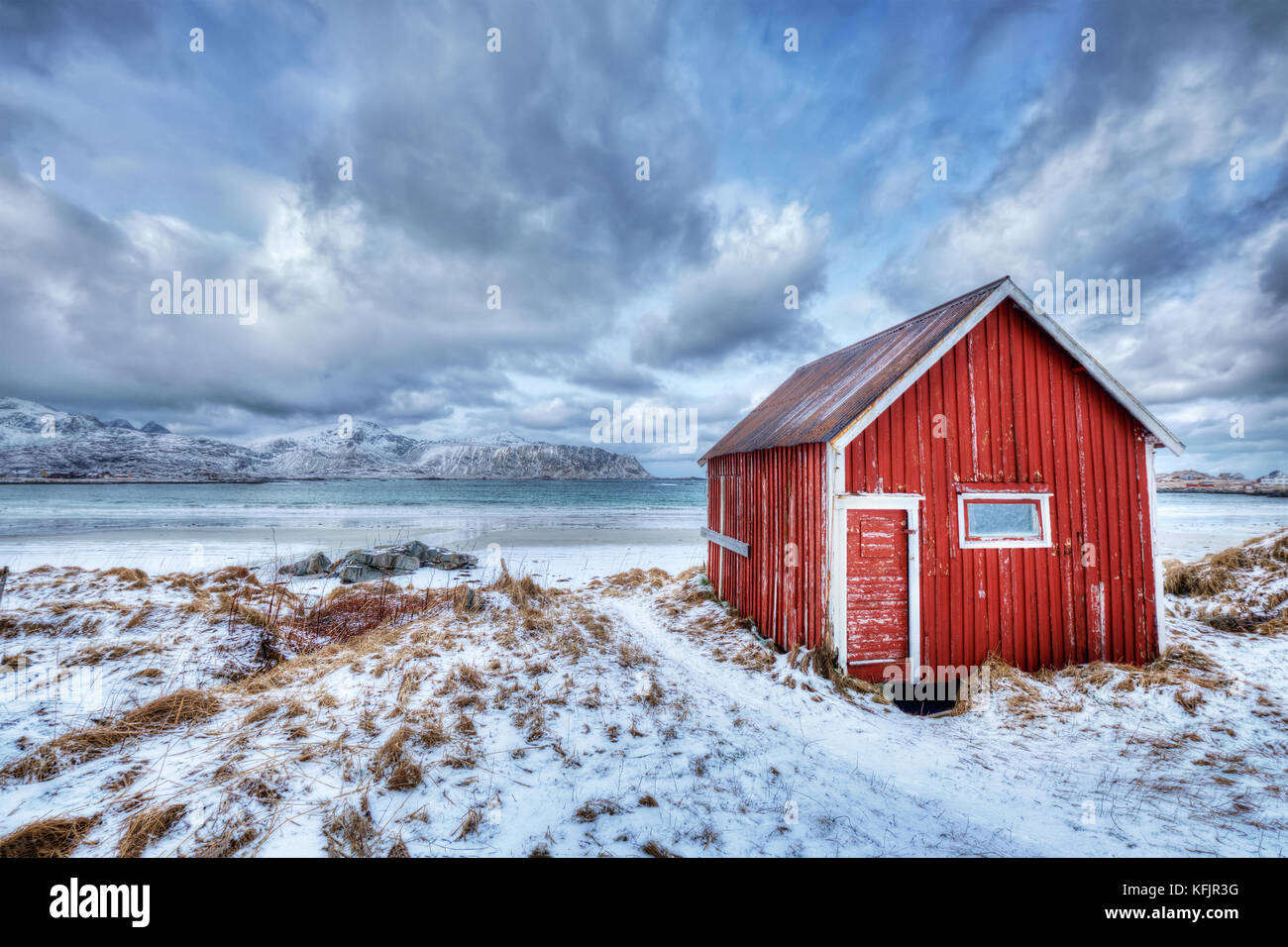 Red rorbu house shed on beach of fjord, Norway Stock Photo - Alamy