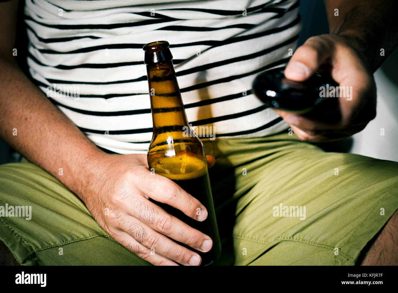 Man watching tv drinking beer hi-res stock photography and images - Alamy