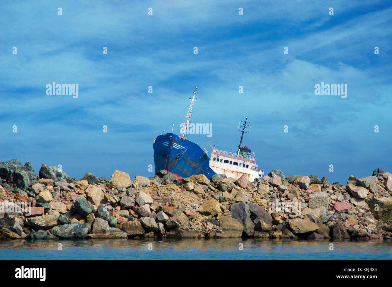 a sinking cargo ship after hitting a rocky shore Stock Photo - Alamy