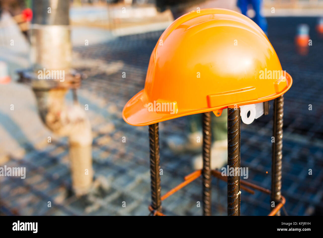 Orange safety helmet at construction site with blurry background Stock ...