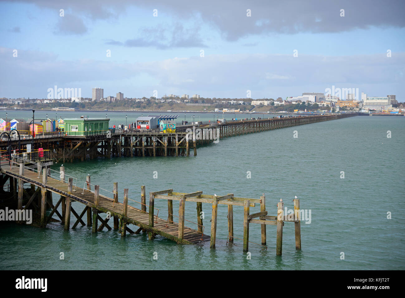 Southend Pier with Southend on Sea town beyond. Old sections of timber ...