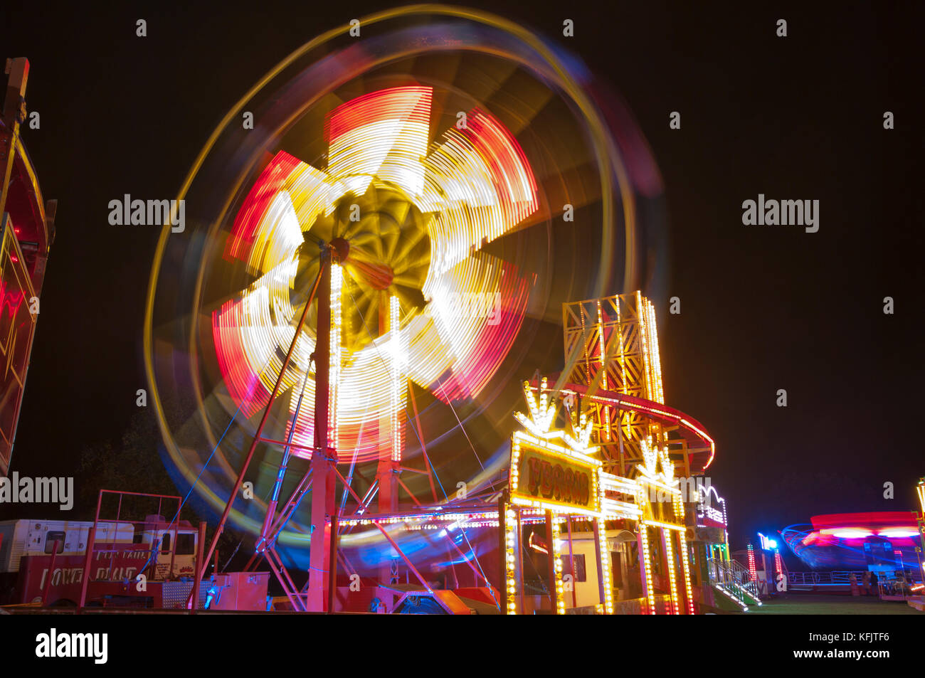 Travelling Funfair At Night With Bright Lights Fairground with brightly ...
