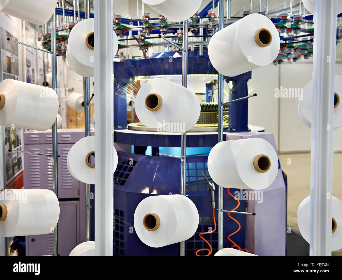 Bobbins with a white thread at the garment factory Stock Photo - Alamy