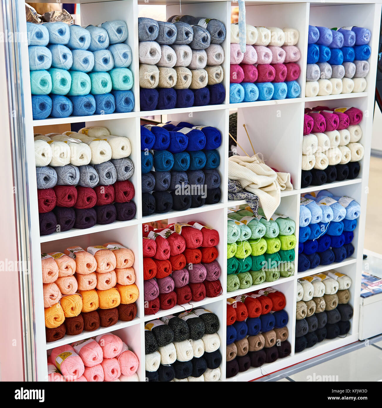 Clews colored wool on the shelves of the store Stock Photo - Alamy