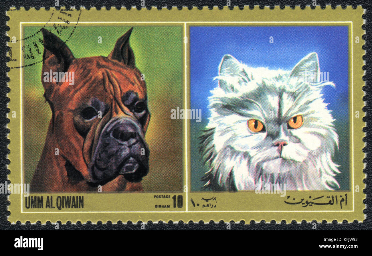 A postage stamp printed in Umm al Qiwain shows cat and dog from series ...