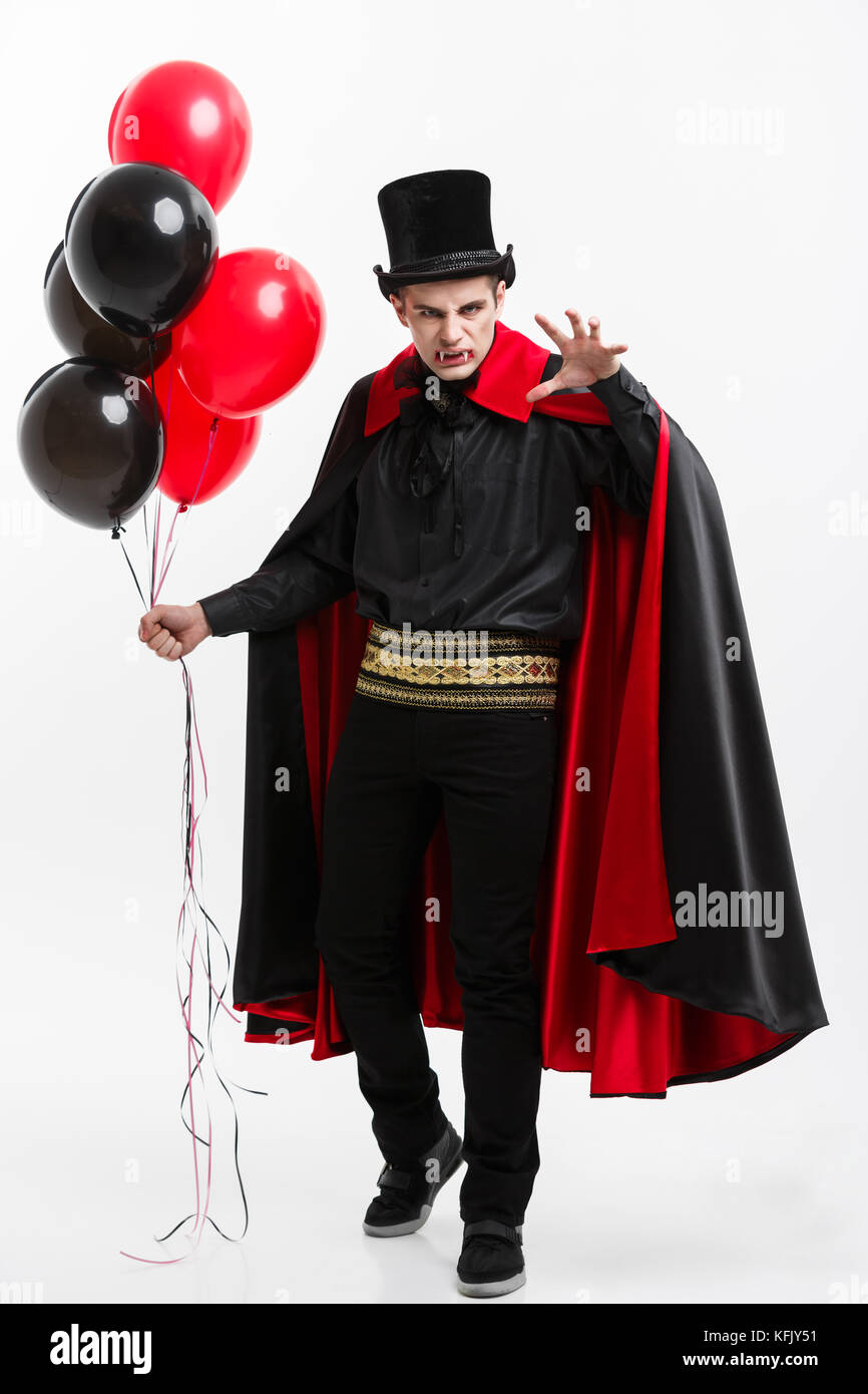 Full-lenght Portrait of handsome caucasian Vampire in black and red ...