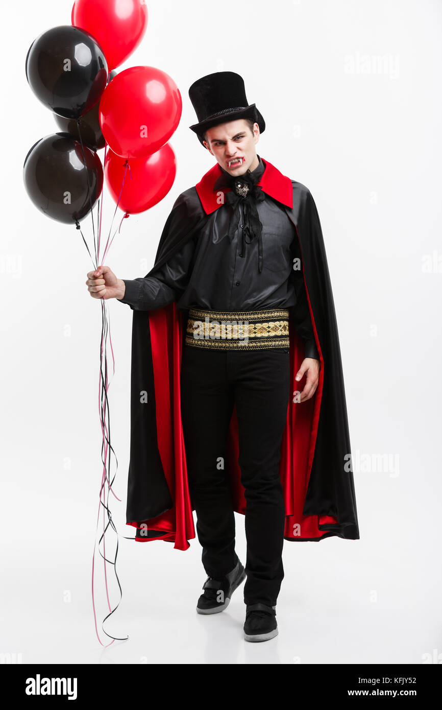Full-lenght Portrait of handsome caucasian Vampire in black and red ...