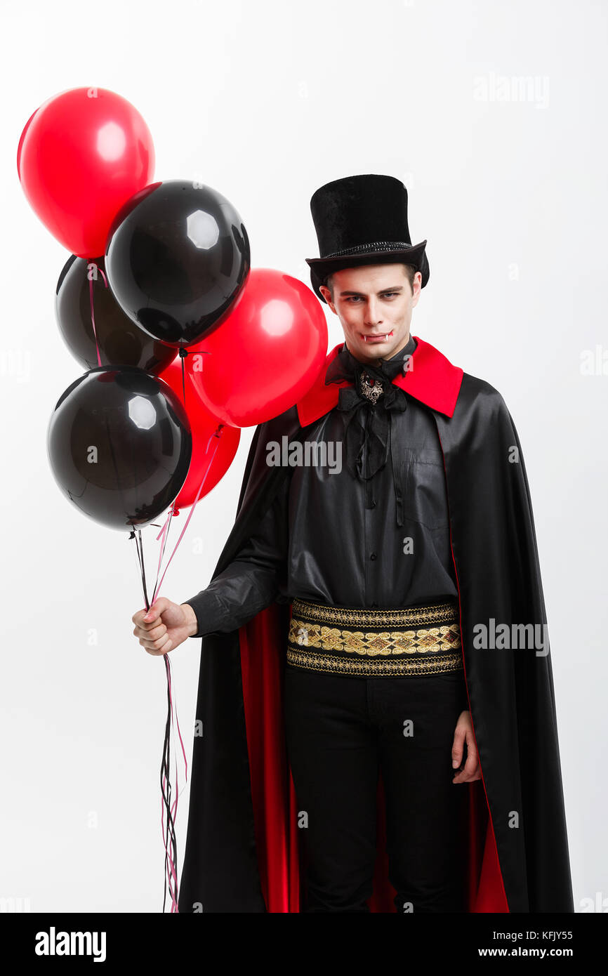 Full-lenght Portrait of handsome caucasian Vampire in black and red ...