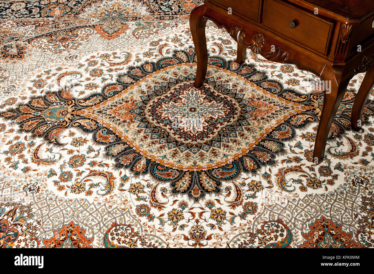 antique table on the decorated oriental carpet Stock Photo - Alamy