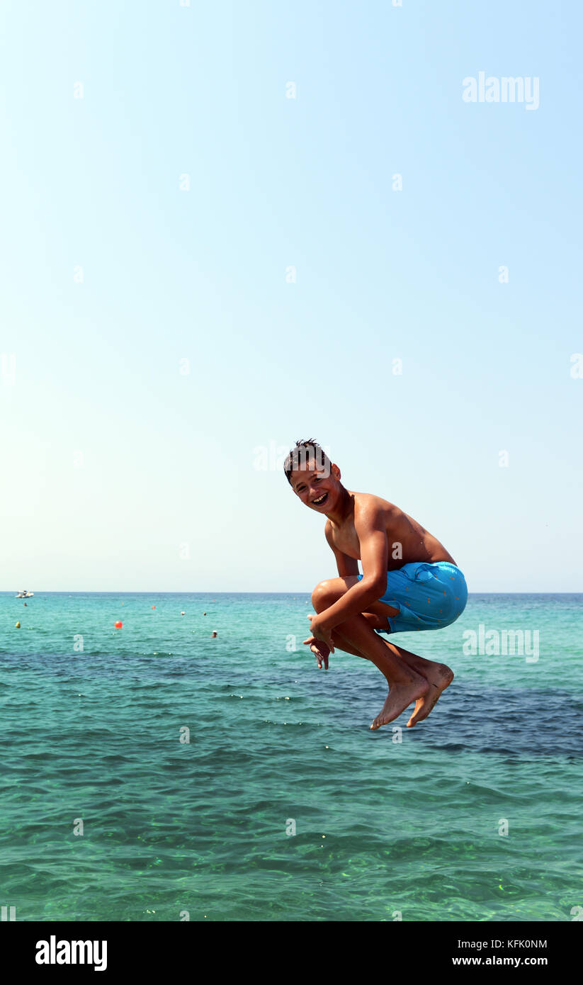 Greek boys jumping to the ocean in Siviri, Chalkidiki, Greece Stock ...